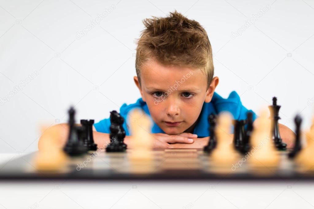 Boy playing chess — Stock Photo © Bigandt #54247105