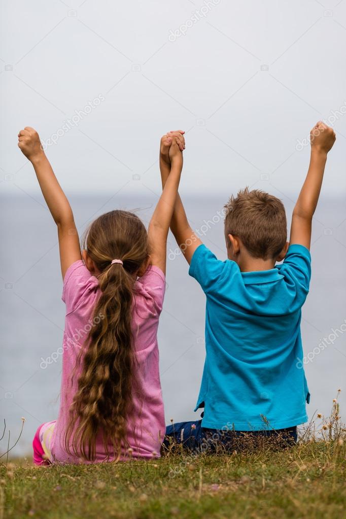 Kids with raised arms Stock Photo by ©Bigandt 66233323