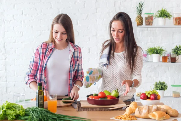 Two girls preparing dinner in a kitchen concept cooking, culinary ...