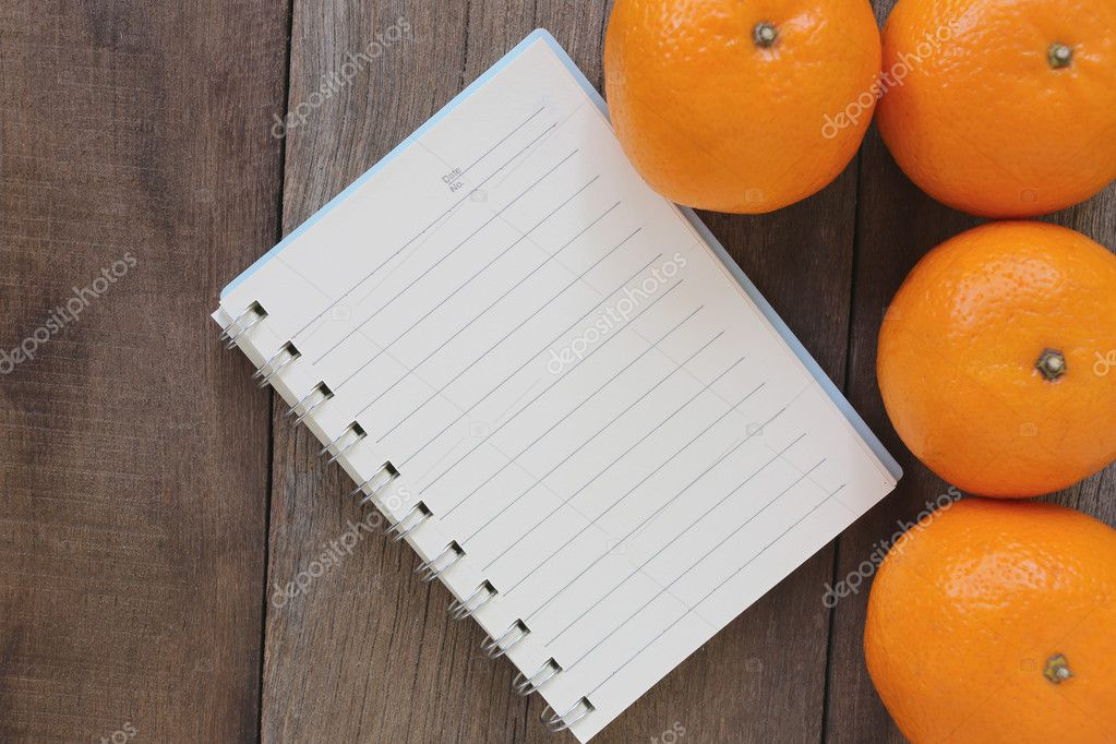 Notebook and Mandarin oranges placed on the old wooden floor. — Stock ...