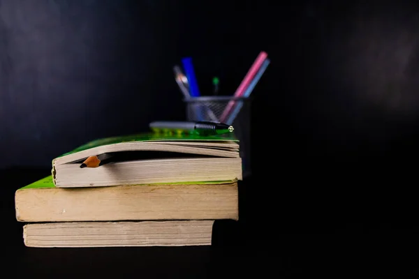 Front close up shot of books with a pencil put between pages of a book ...
