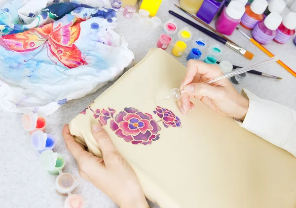 Batik process: artist paints on fabric, Batik painting - Stock Image ...