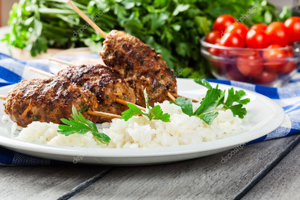 Barbecued kofta with rice on a plate — Stock Photo © fotek #84104060
