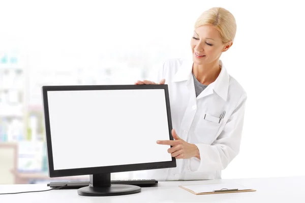 Pharmacist standing behind the computer - Stock Image - Everypixel