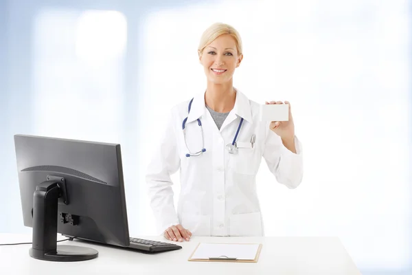 Health care worker standing at working desk - Stock Image - Everypixel
