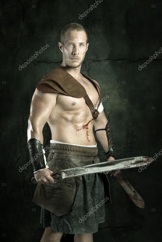 Gladiator posing with swords Stock Photo by ©luislouro 88469054