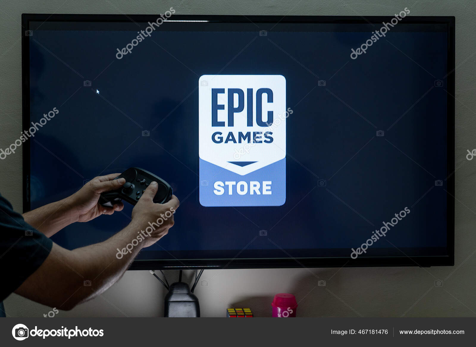 Man holding steam controller waiting for the epic game store to load an ...