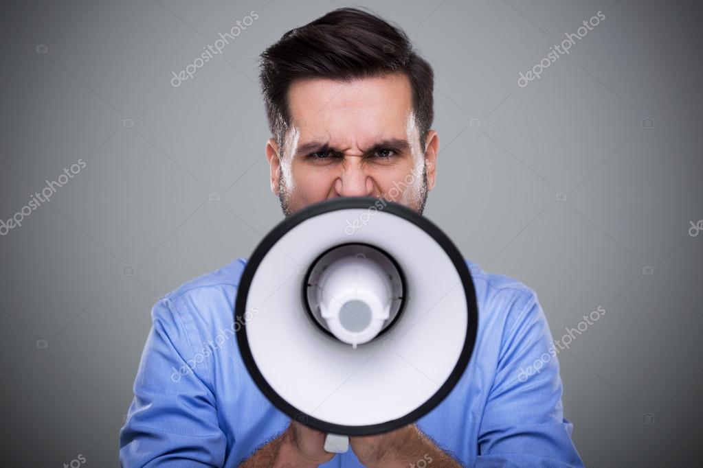 Man shouting through megaphone Stock Photo by ©pikselstock 95474630