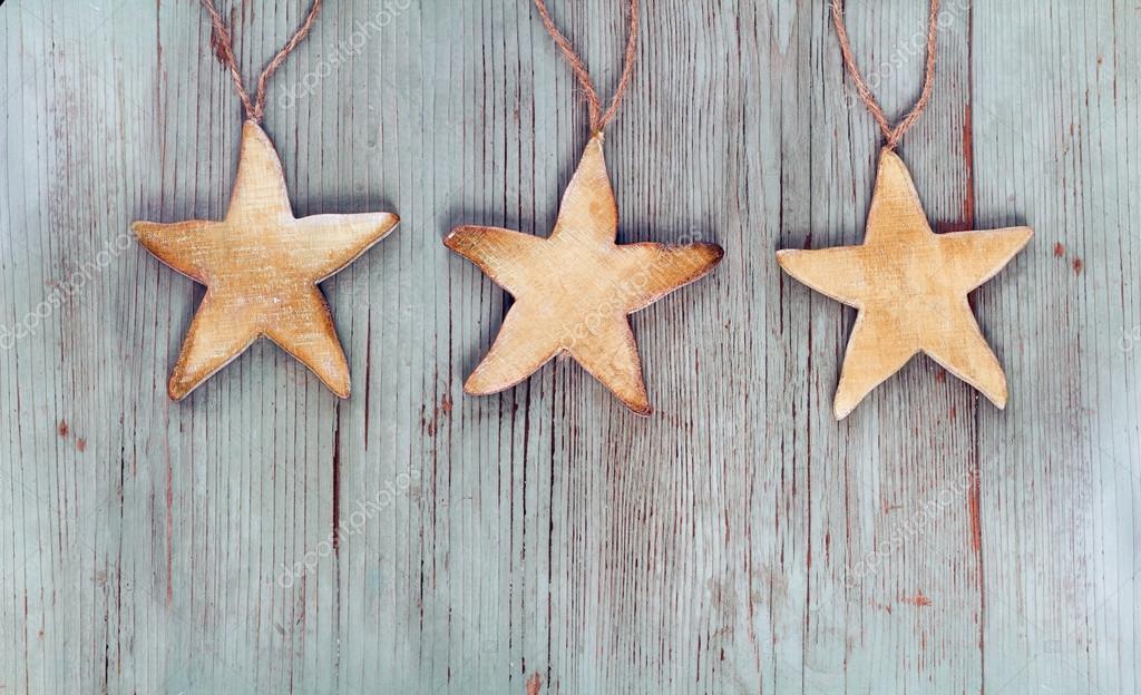 Three stars hanging over a weathered wooden board Stock Photo by ...