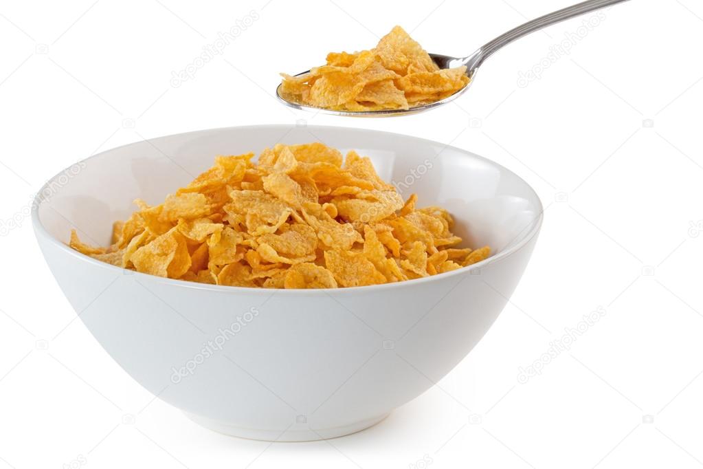 Bowl of cornflakes with a spoon on white background Stock Photo by ...