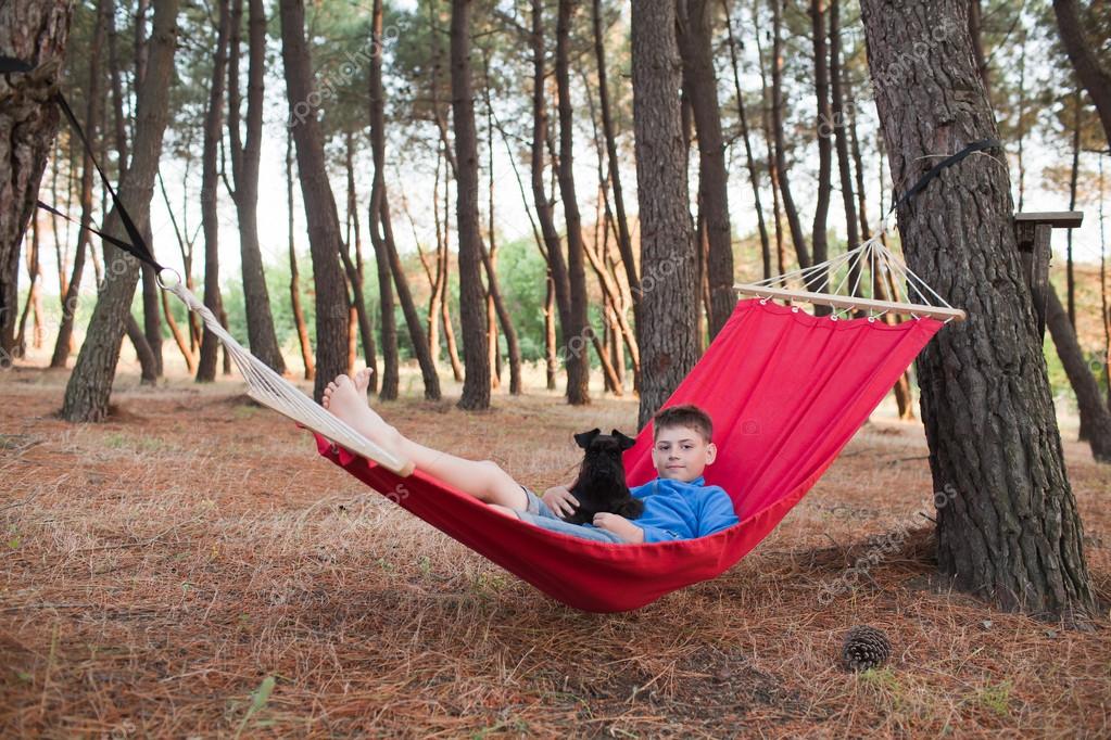 Boy and his dog relaxing in hammock Stock Photo by ©waldru 85150930