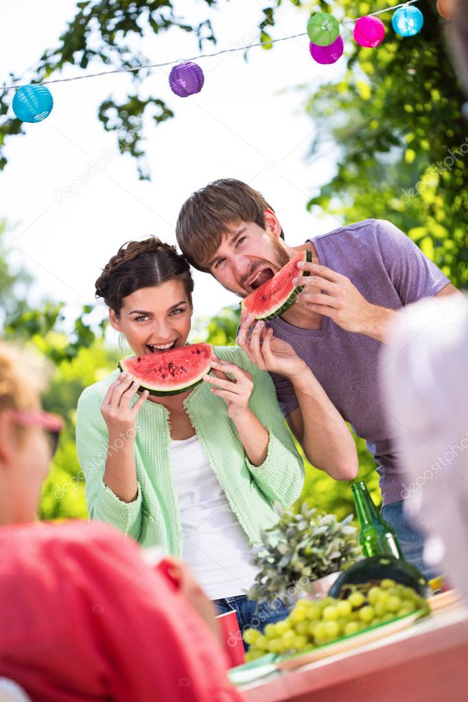 Happy people eating watermelon Stock Photo by ©photographee.eu 104838096