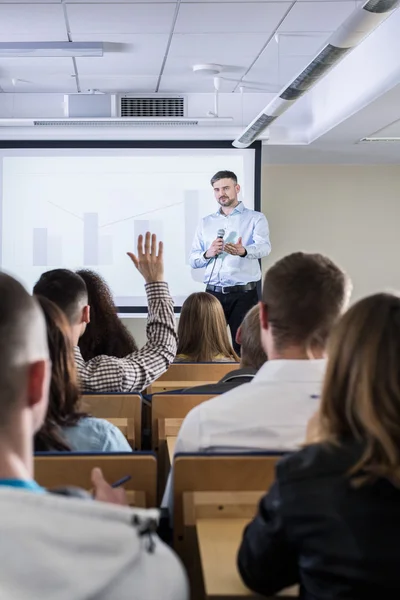 Activating his students during a lecture on economy - Stock Image ...