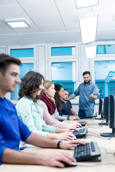 Computer lesson under the watchful eye of an expert - Stock Image ...