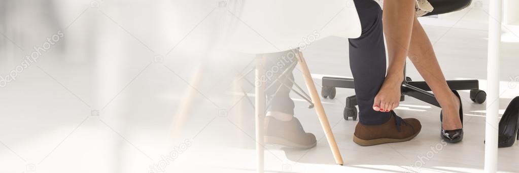 Romance under office table... — Stock Photo © photographee.eu #123230098