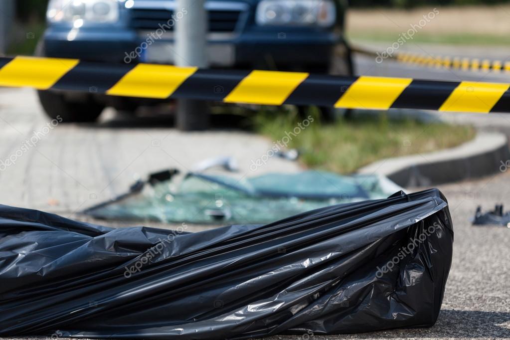 Dead body in a plastic bag lying on the street Stock Photo by ...