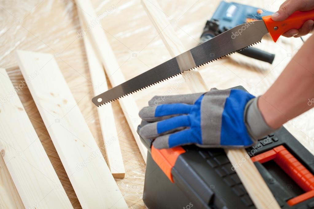 Using hand saw during house renovation Stock Photo by ©photographee.eu ...