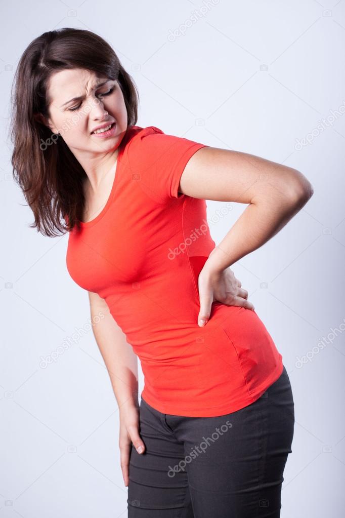 Young woman having back pain — Stock Photo © photographee.eu #60729847