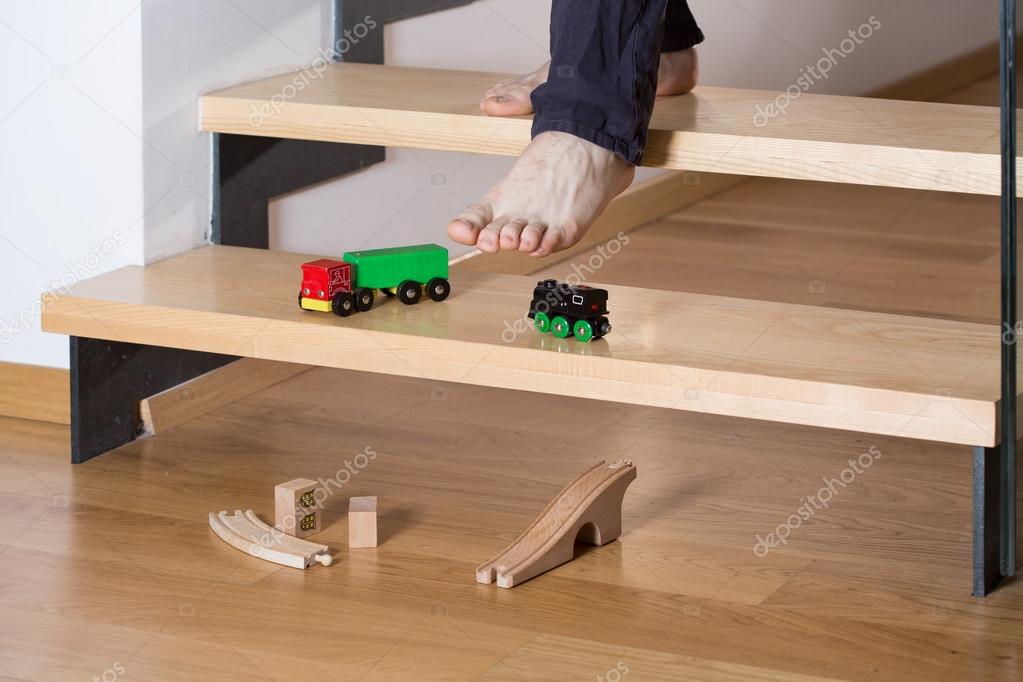 Man stepping on toys on stairs — Stock Photo © photographee.eu #70624507