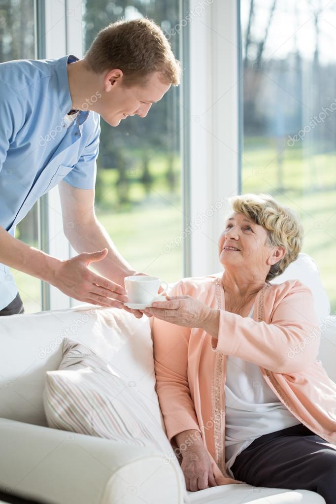 Handing a cup of tea — Stock Photo © photographee.eu #73711615