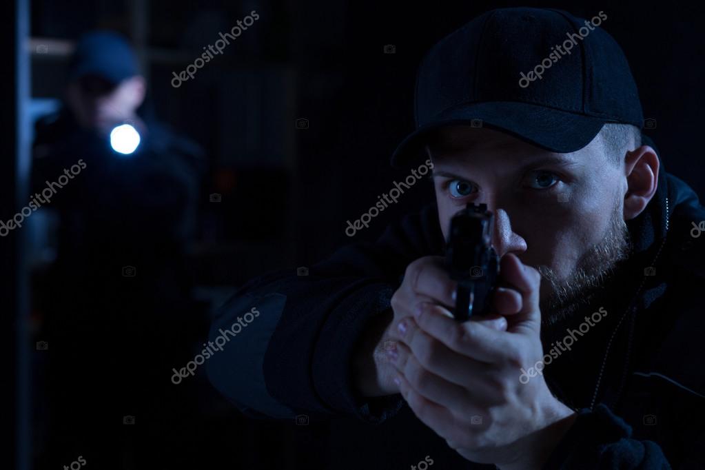 Officer pointing gun at criminal — Stock Photo © photographee.eu #83921664