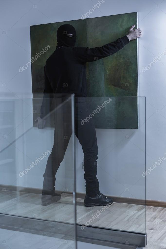 Masked burglar stealing valuable picture — Stock Photo © photographee ...