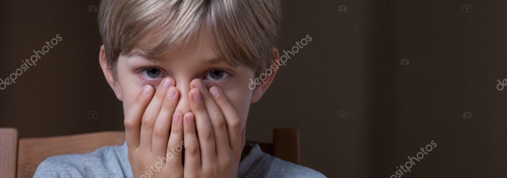 Scared boy covering his face — Stock Photo © photographee.eu #95727688