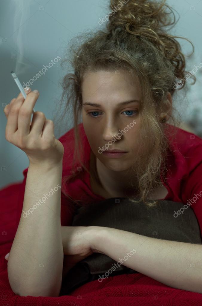 Miserable woman smoking cigarette Stock Photo by ©photographee.eu 95731022