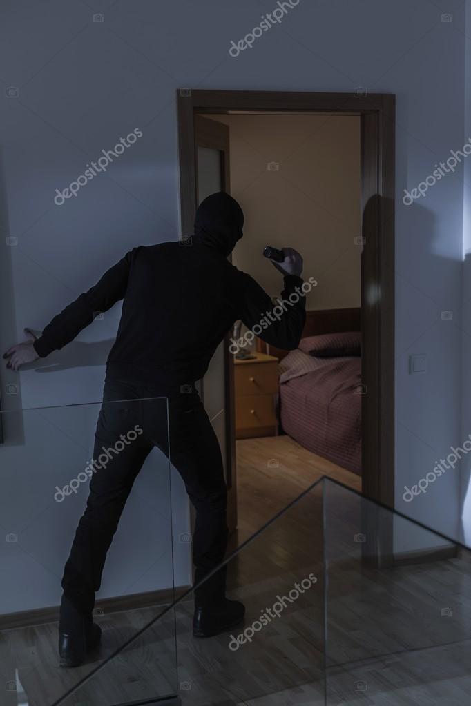Masked intruder in house — Stock Photo © photographee.eu #96141432