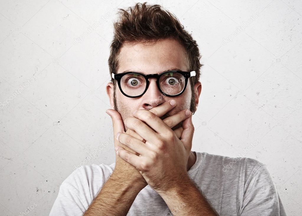 Surprised young man wearing eyeglasses — Stock Photo © kantver #58418679 Surprised young man wearing eyeglasses — Stock Photo © kantver #58418679