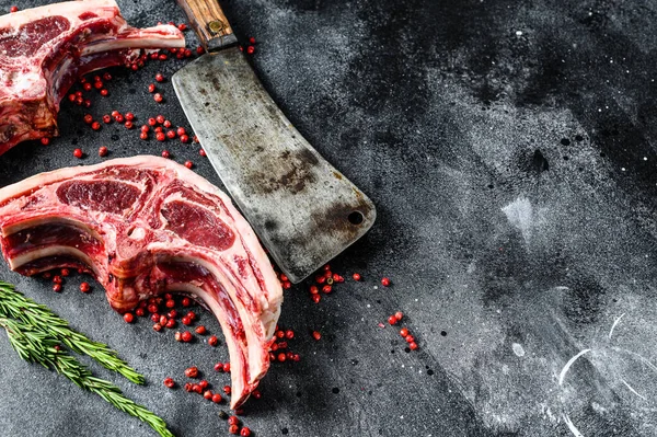 Raw lamb cutlets fresh cut with meat cleaver. Black background. Top ...