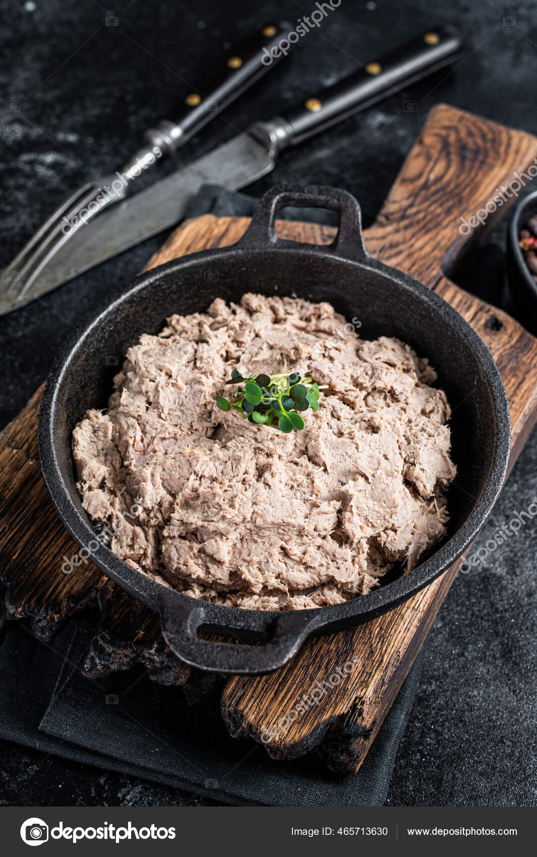 Duck pate Rillettes de Canard in a pan with greens. Black background ...