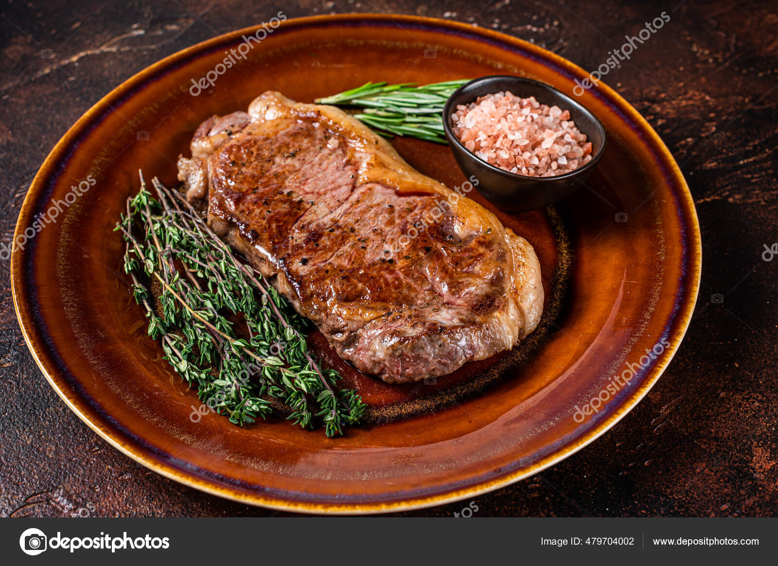 Roasted new york strip beef meat steak or striploin in a rustic plate ...