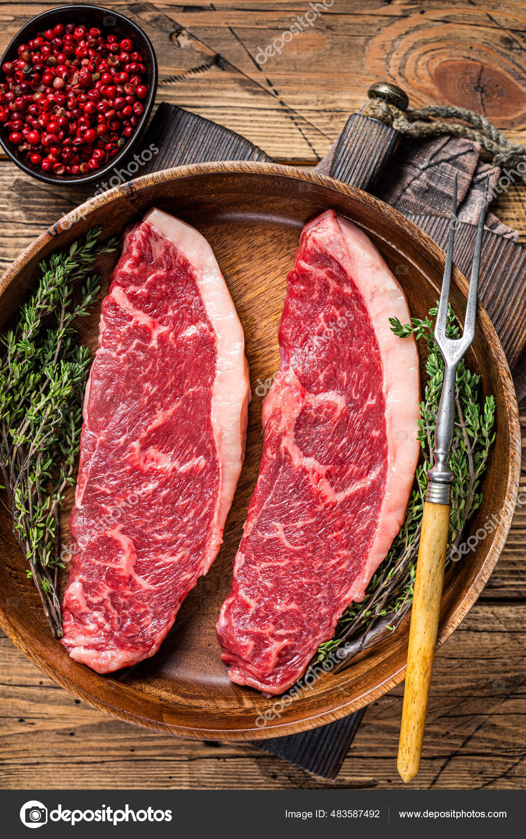 Uncooked Raw top sirloin cap beef meat steaks in a wooden plate with ...