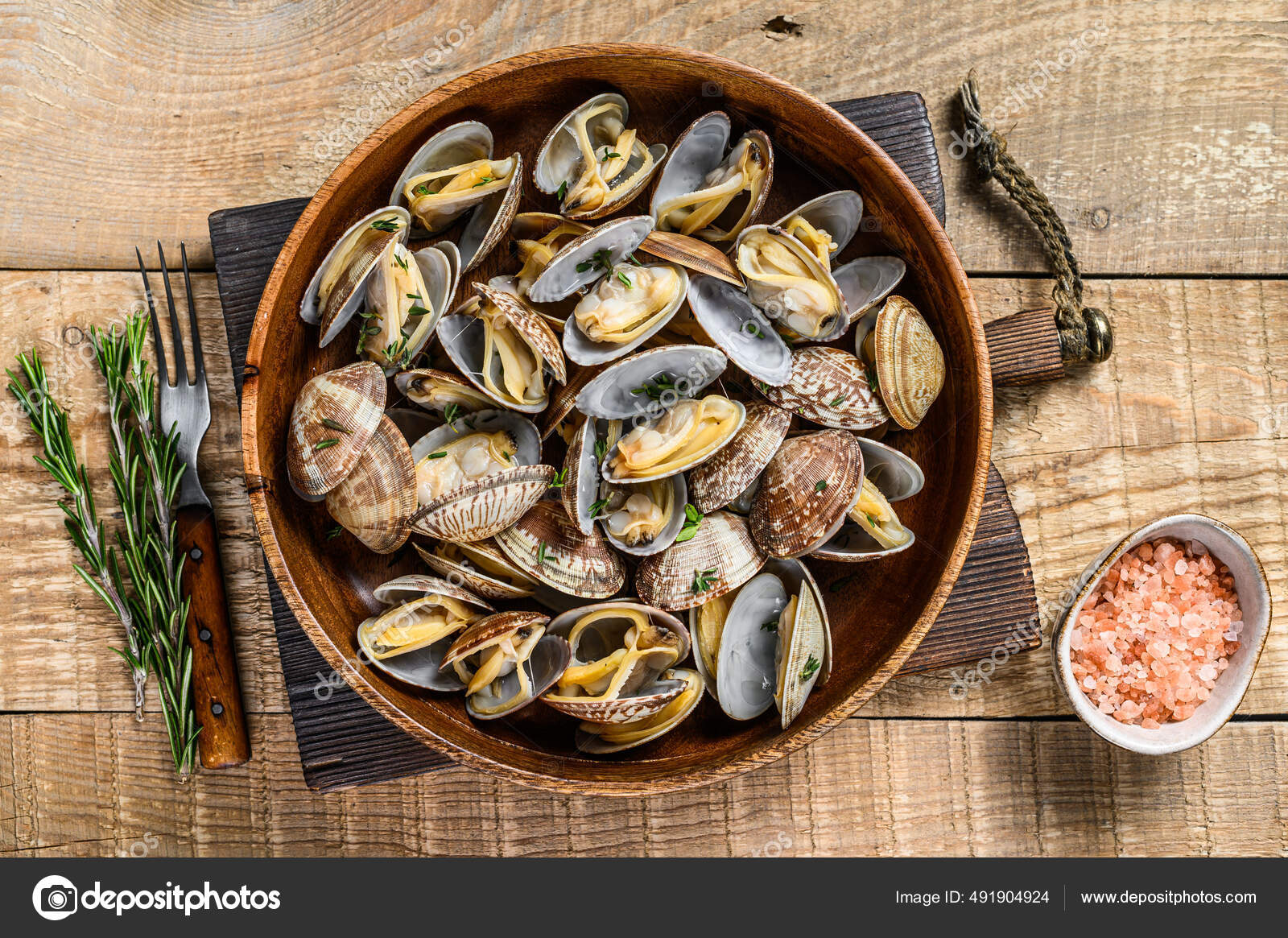 Steamed cooked shells Clams vongole in a wooden plate. wooden ...