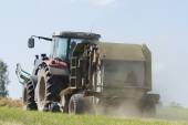 Tractor collecting haystack in the field — Stock Photo © rihardzz #6212366