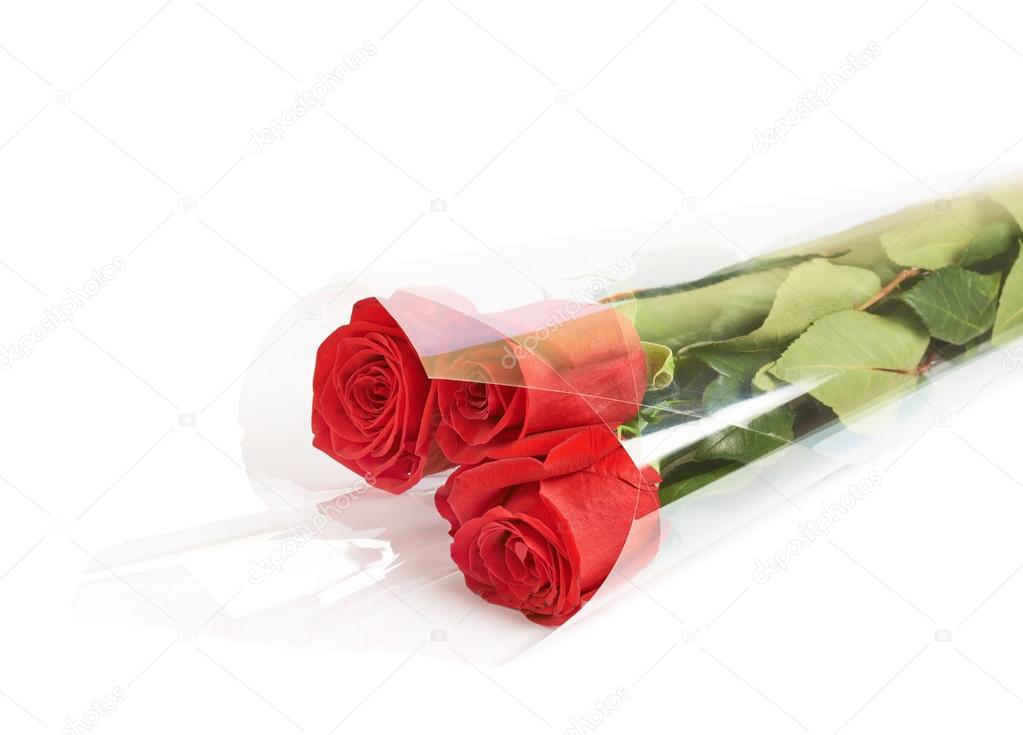 Three red roses in a wrapping — Stock Photo © exopixel #68180523
