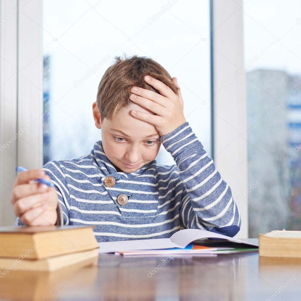 Boy sitting over the pile of homework — Stock Photo © exopixel #69282837
