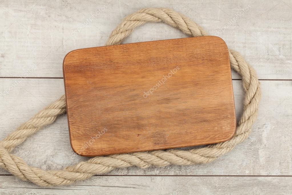 Wooden board with ship rope Stock Photo by ©axesor 68775513