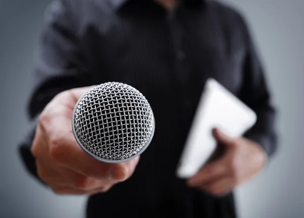 Hand holding a microphone - Stock Image - Everypixel