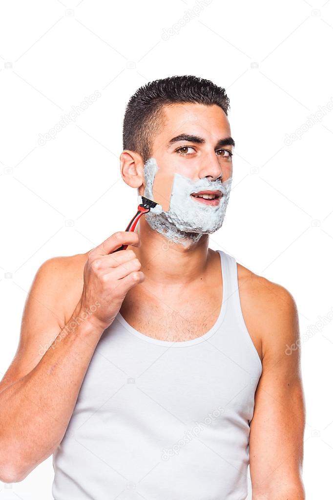 Handsome man shaving his beard Stock Photo by ©brasoveanub 53129381