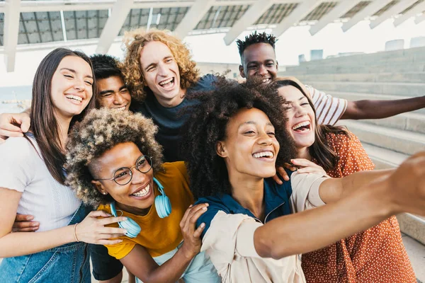 Group of young multicultural people taking selfie portrait with phone ...
