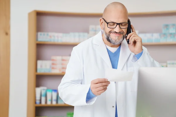 Pharmacist checking a prescription over the phone - Stock Image ...