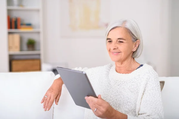 Senior Chinese Woman With Tablet Computer Whilst Relaxing On Sof Stock ...