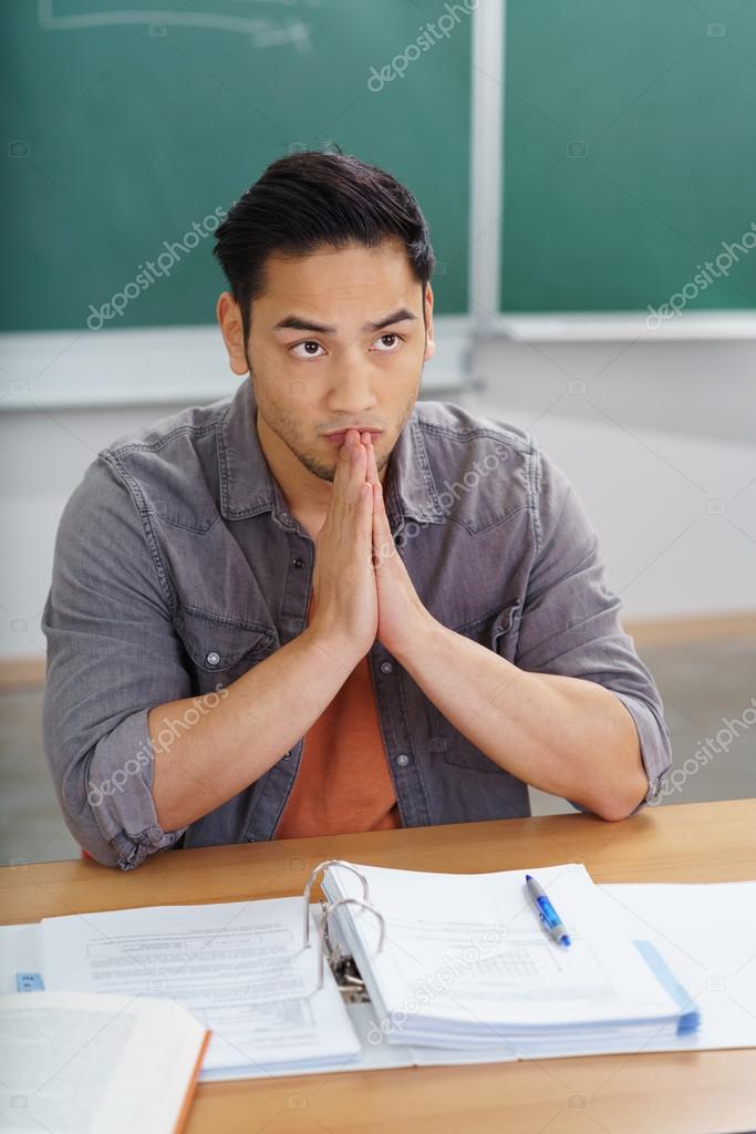 Asian male student thinking about his class work Stock Photo by ©racorn ...