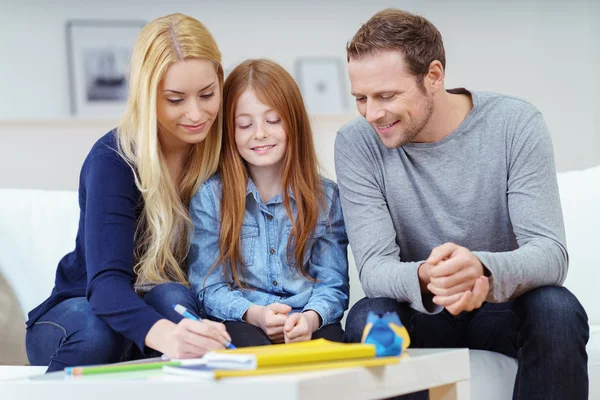 Happy family doing homework together - Stock Image - Everypixel