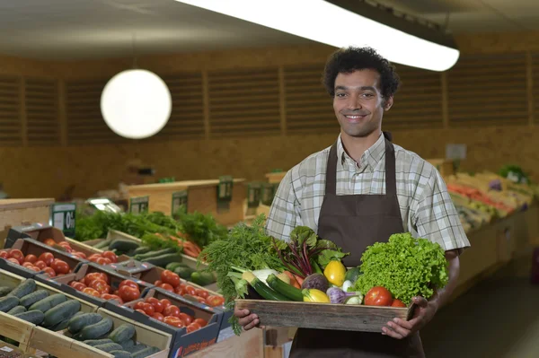 Grocery clerk working in produce aisle of supermarket store - Stock ...