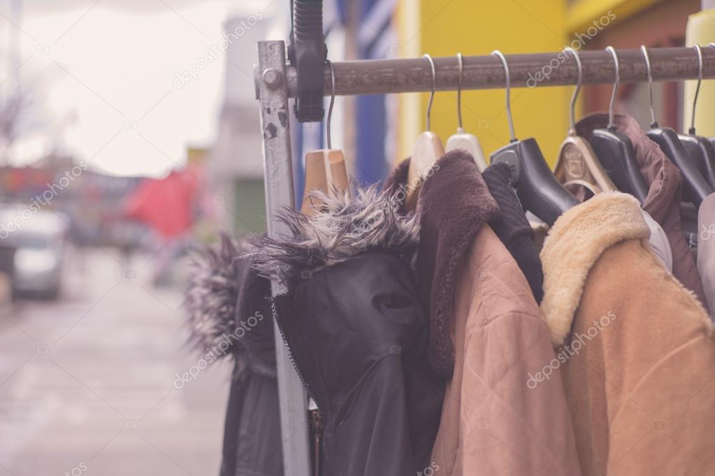Winter jackets hanging on rail outside — Stock Photo © lofilolo #69952817