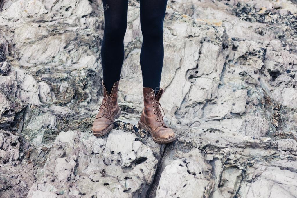 Woman in hiking boots standing on rocks Stock Photo by ©lofilolo 91031384