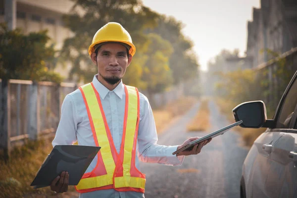 Engineers with on-hand work equipment in construction sites - Stock ...